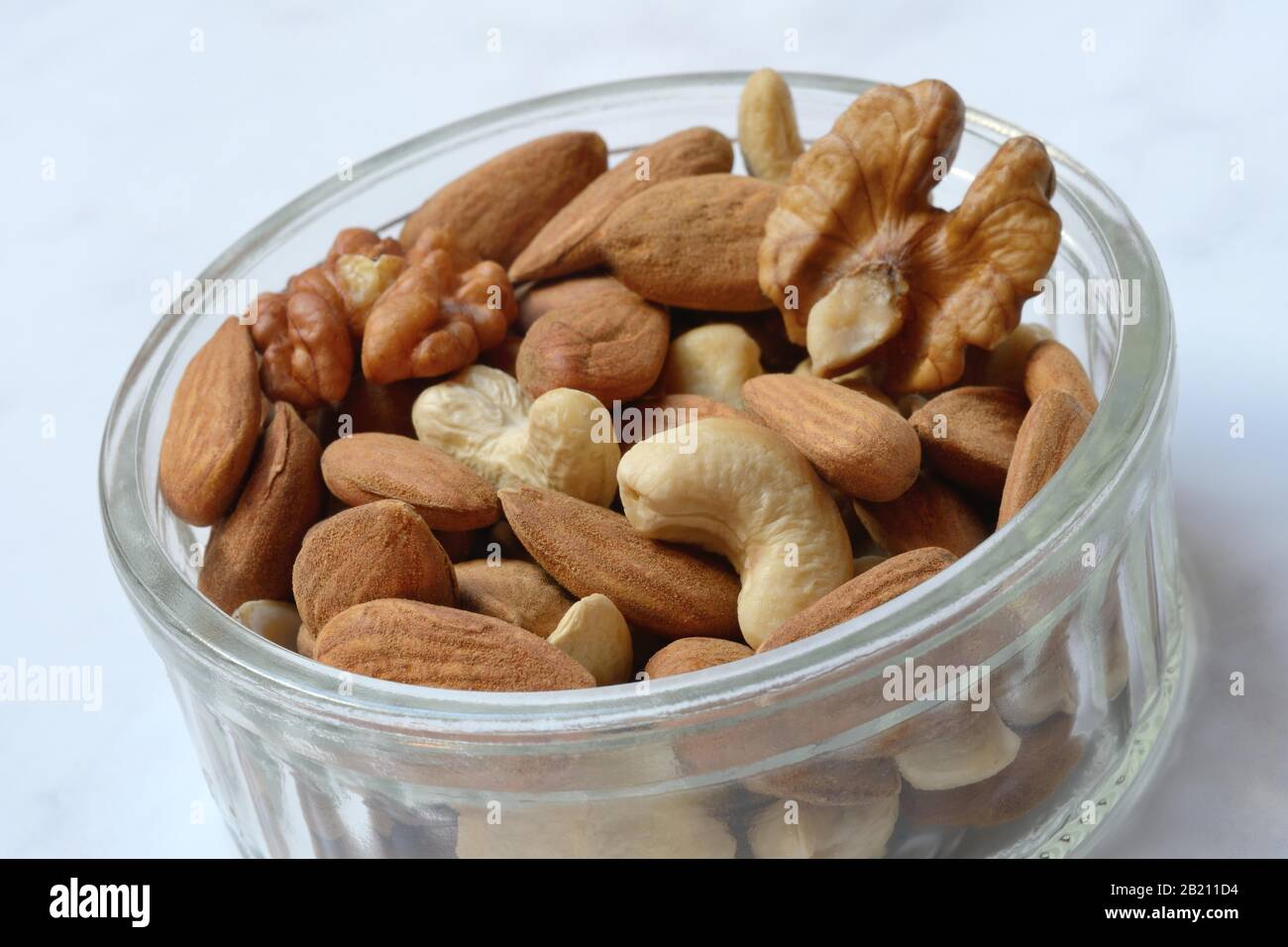 Mixed nuts in glass bowl, Germany Stock Photo - Alamy