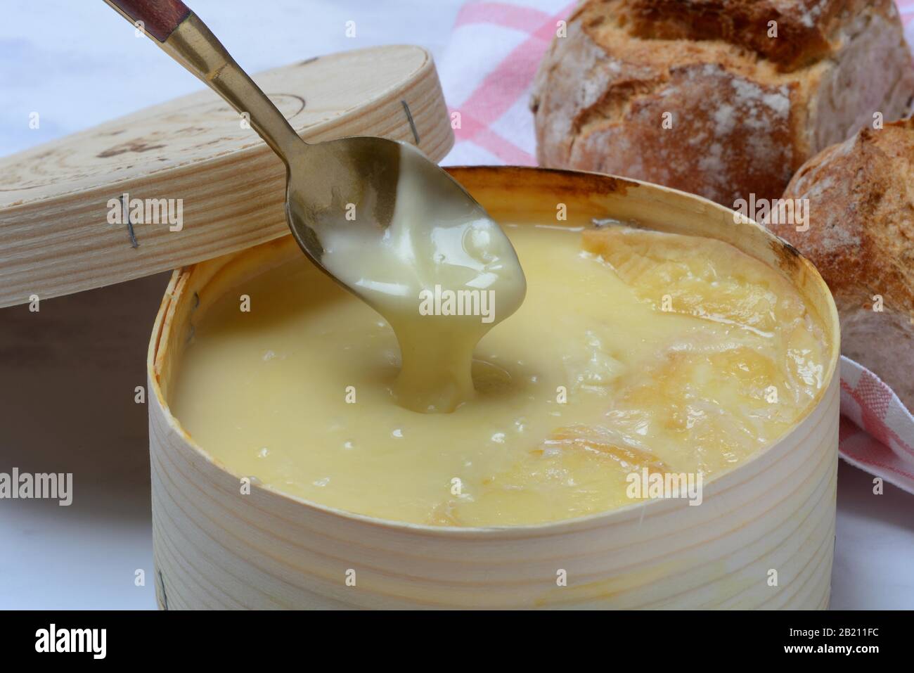 Vacherin Mont d'Or, Swiss soft cheese flows from Loeffel, Germany Stock ...