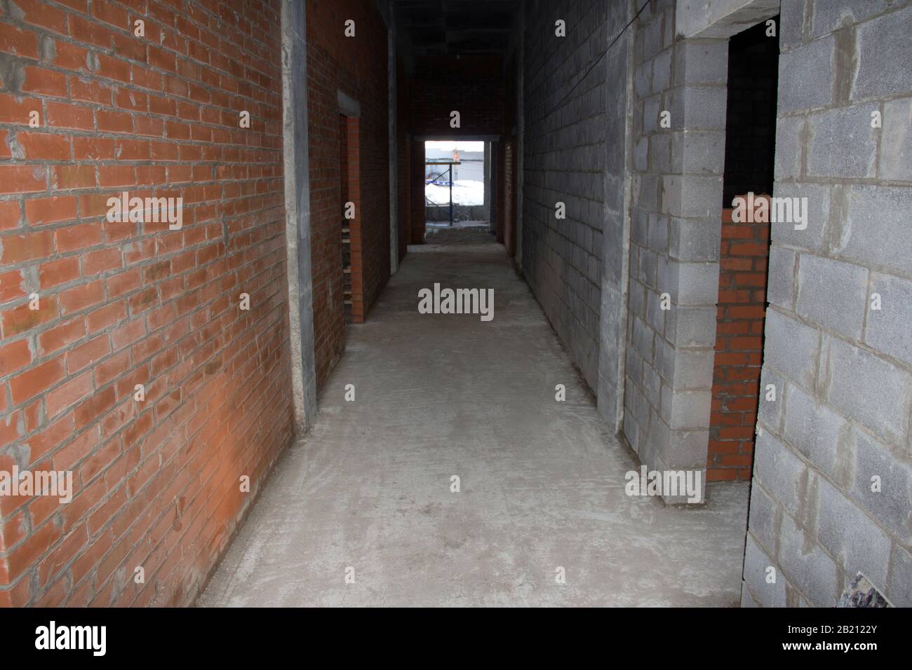 Inside a building under construction. Kipichnye walls and concrete ...