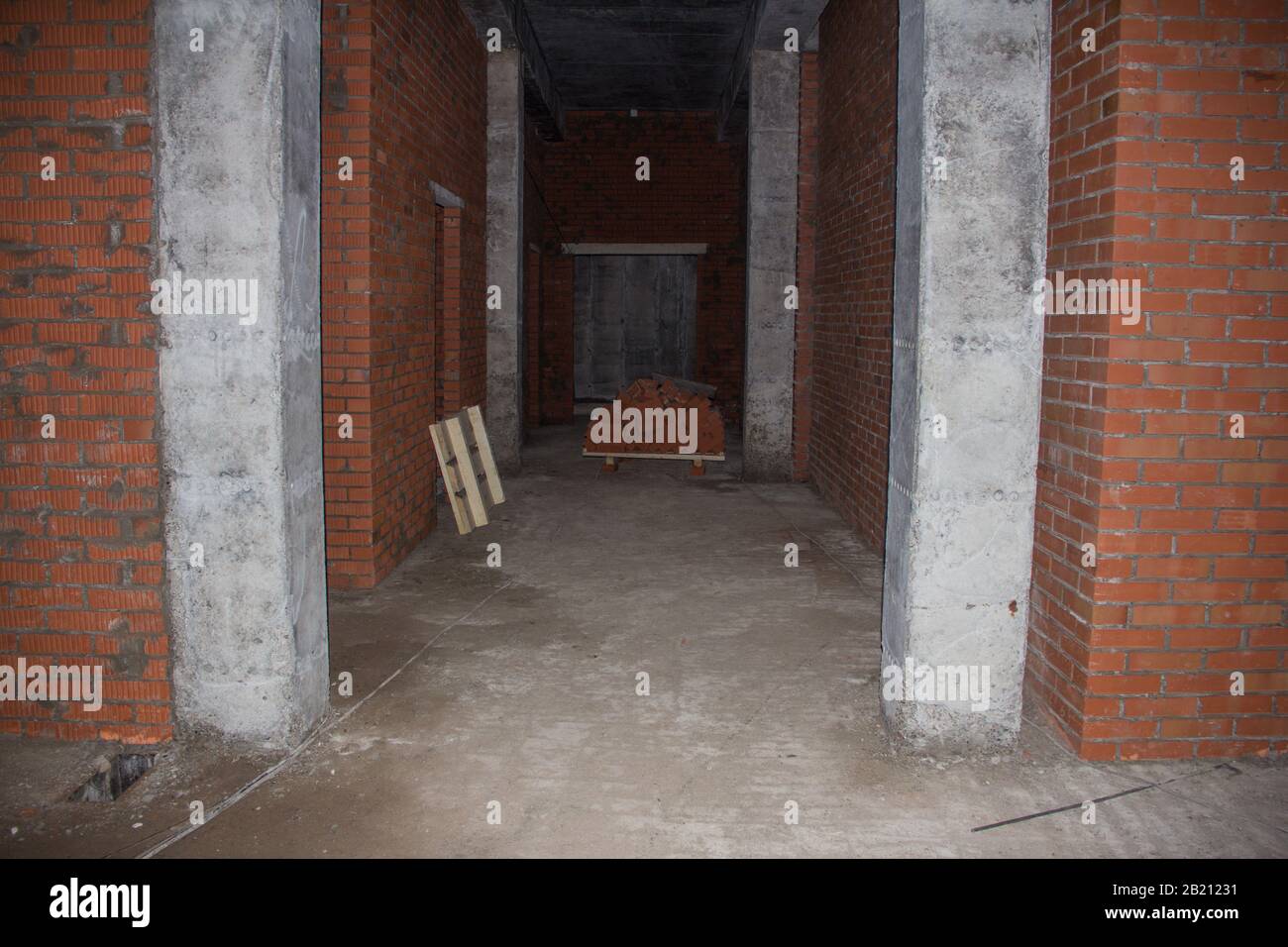 Inside a building under construction. Kipichnye walls and concrete ...