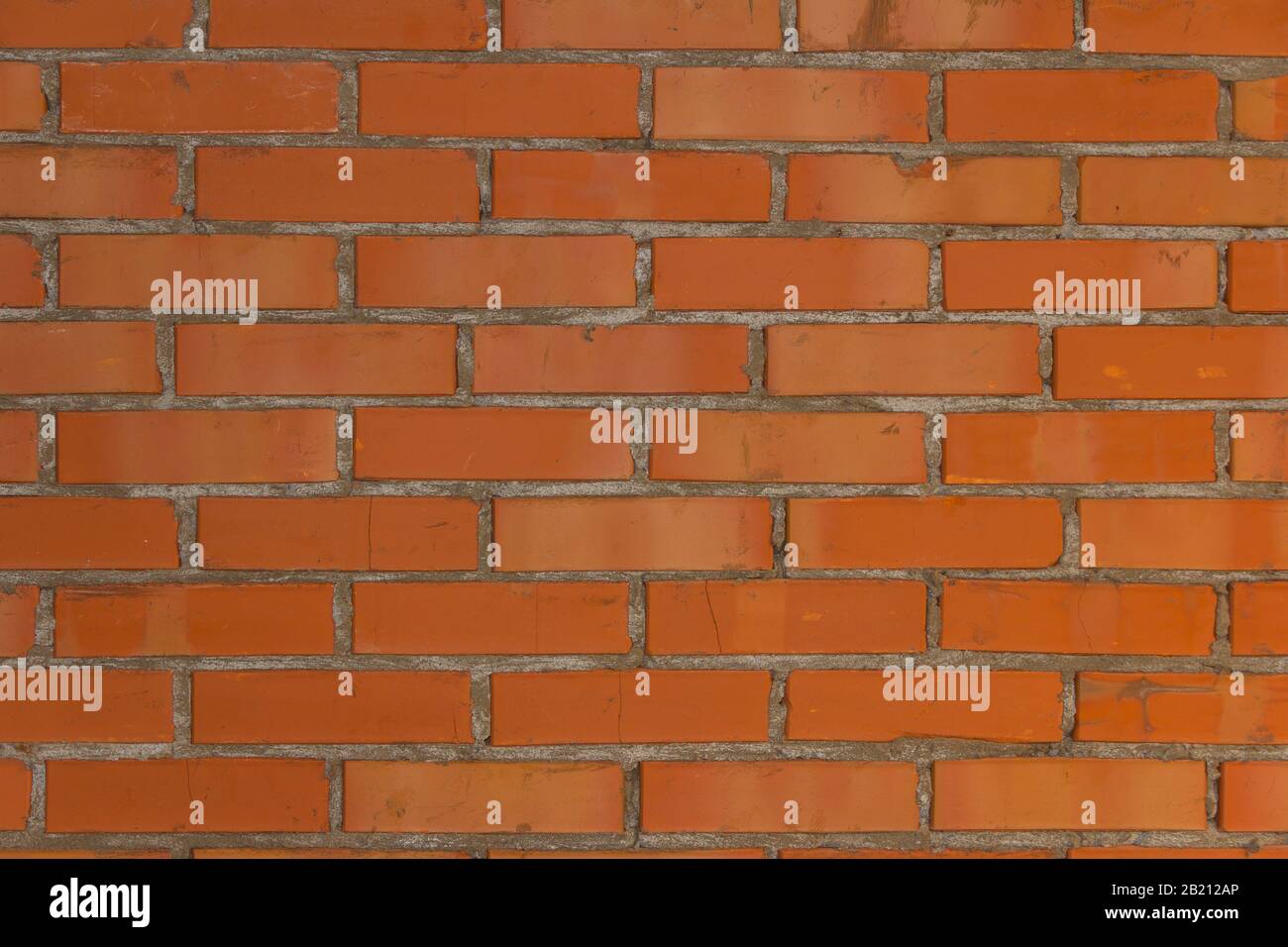 A wall with fresh brickwork in red brick. Brick wall construction Stock ...