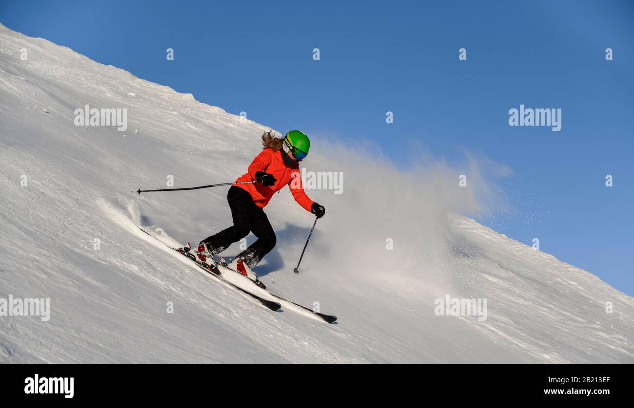 Skier descending steep slope, black piste, blue sky, SkiWelt Wilder ...