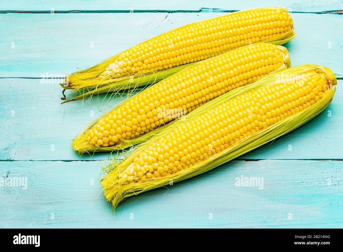 Fresh sweet corn on cobs. Natural organic raw vegetables, healthy food ...