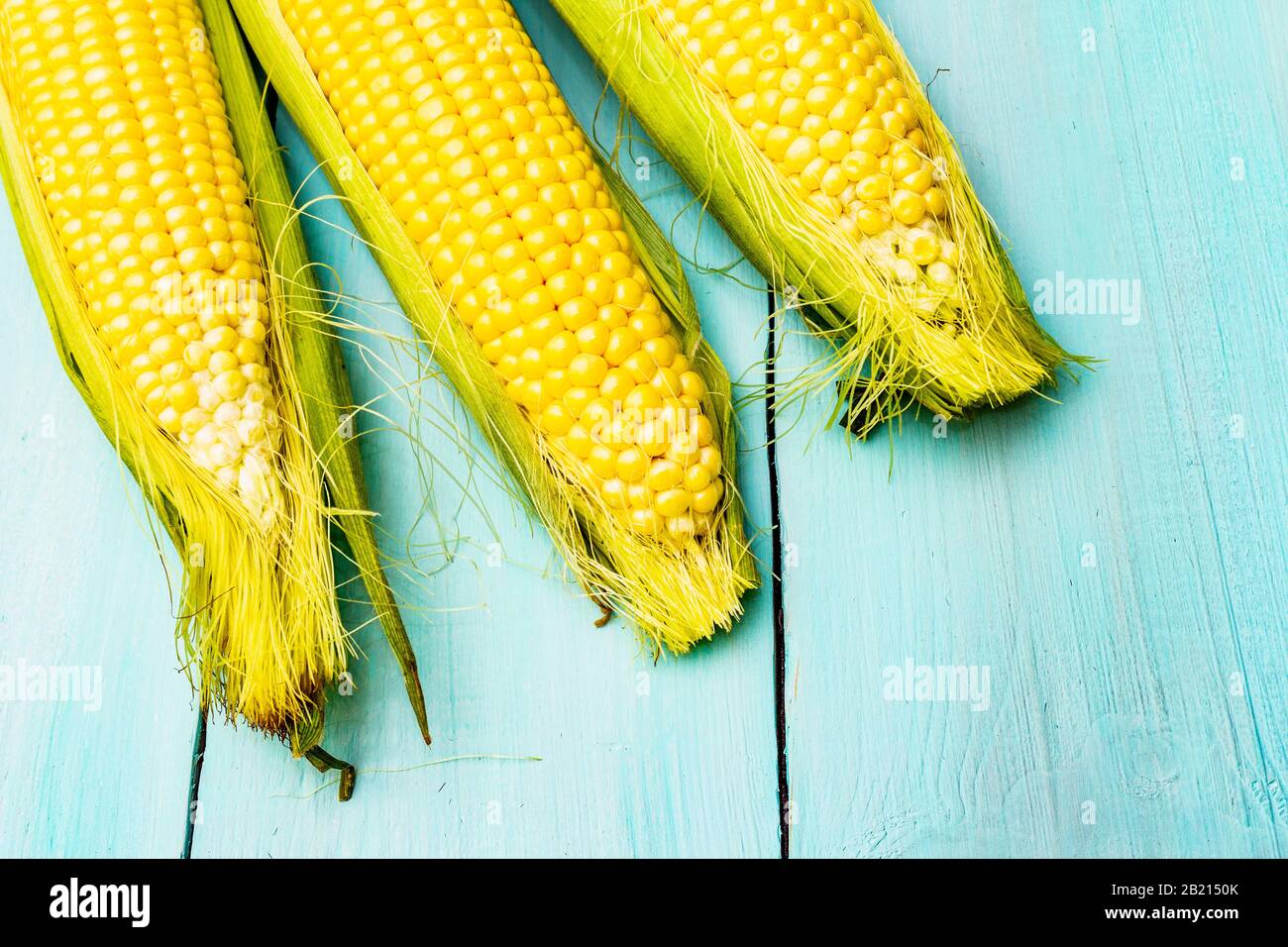 Fresh sweet corn on cobs. Natural organic raw vegetables, healthy food ...