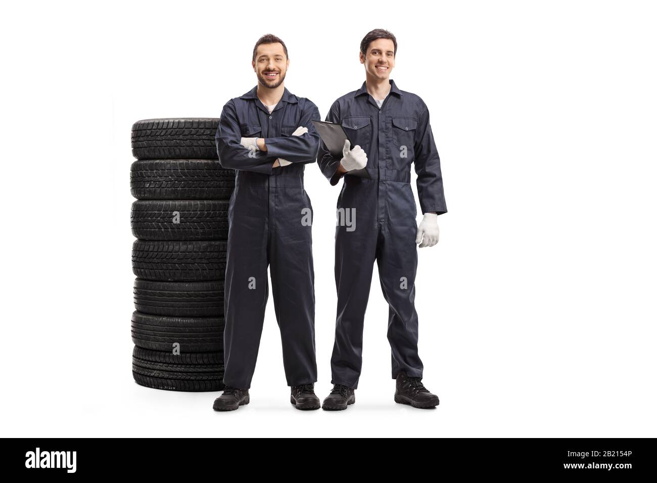 Full length portrait of auto mechanic workers in uniforms with car ...