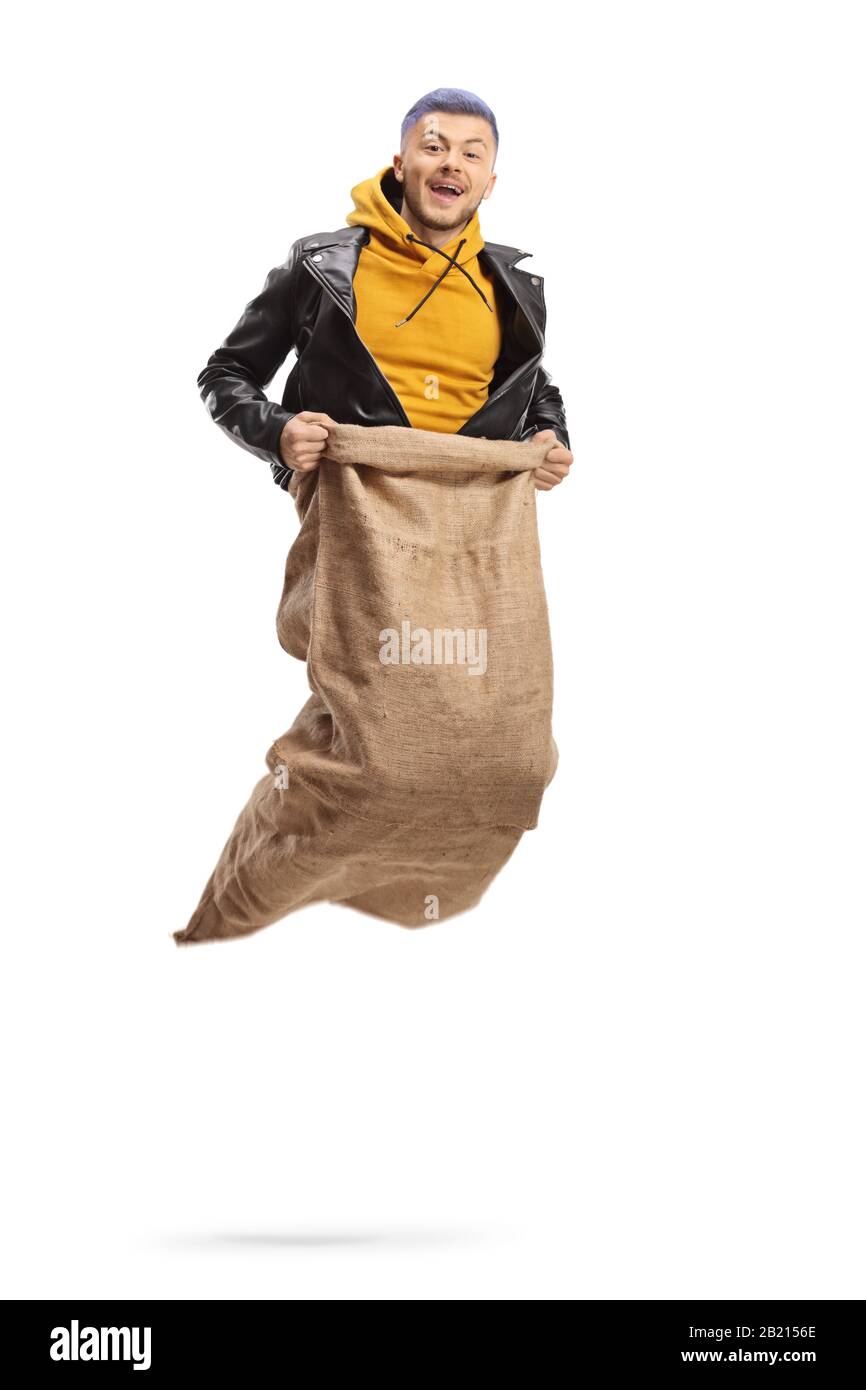 Cheerful young man jumping in a sack isolated on white background Stock ...