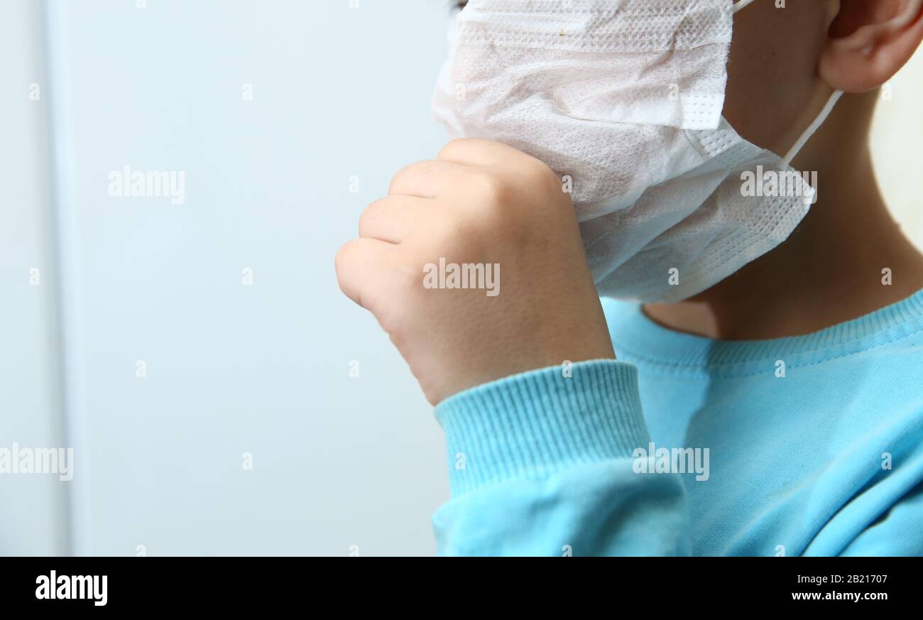 Sick Child wearing surgical mask coughing . Kids wear health masks to ...