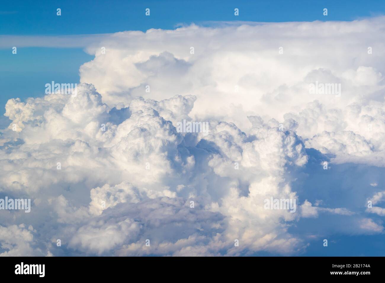 Fluffy white clouds in the atmosphere captured from above by a flying ...