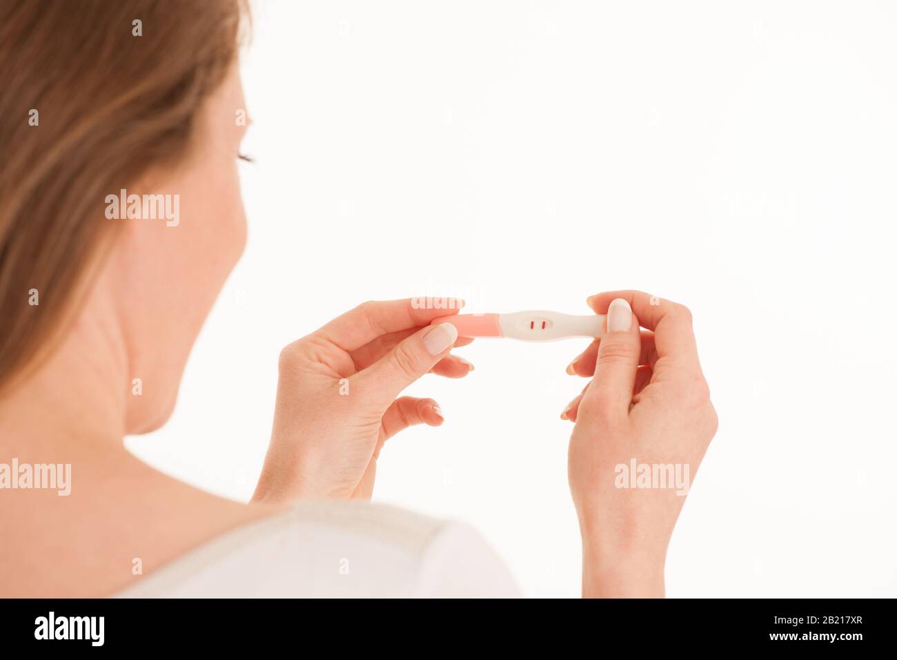 Happy woman with pregnancy test isolated over white background Stock ...