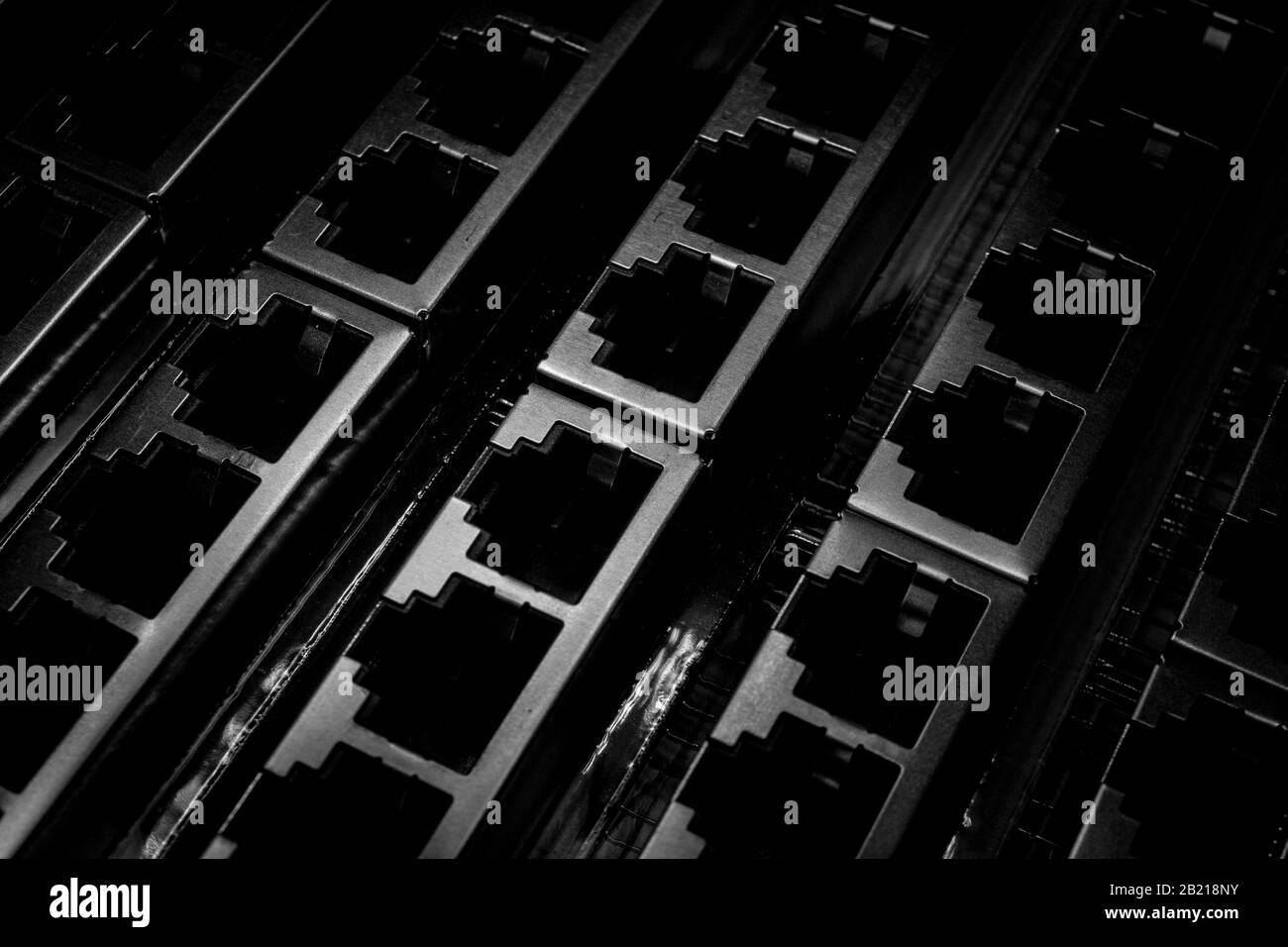 Isolated monochrome close up of closely aligned multiple through hole ...