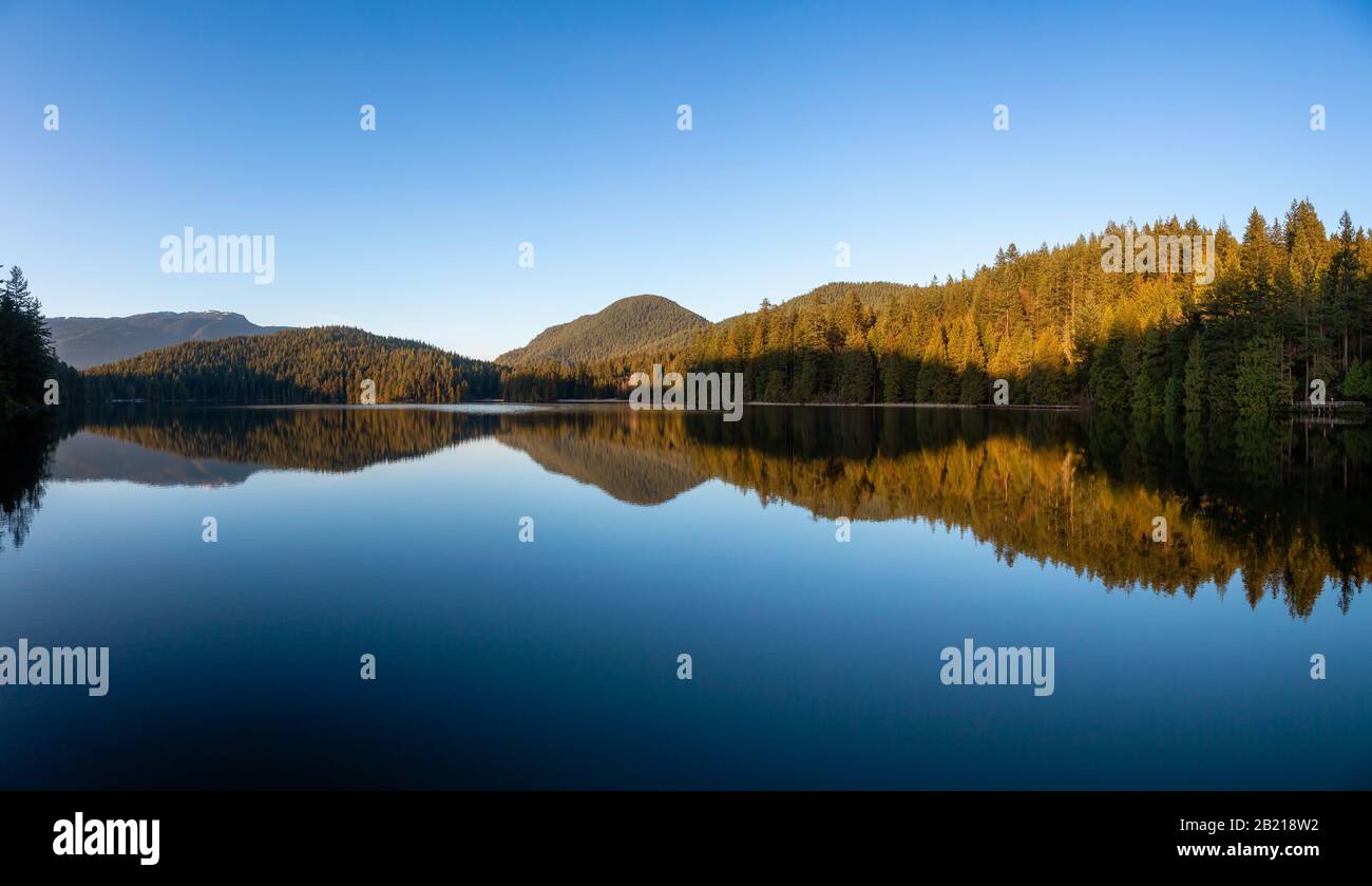 Beautiful and Vibrant panoramic view of a lake surounded by Canadian ...