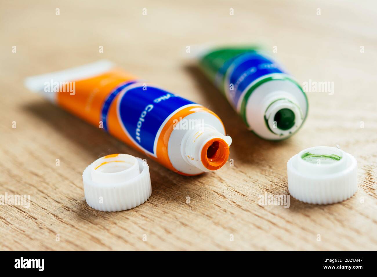 Acrylic paint tubes with orange and green color Stock Photo - Alamy