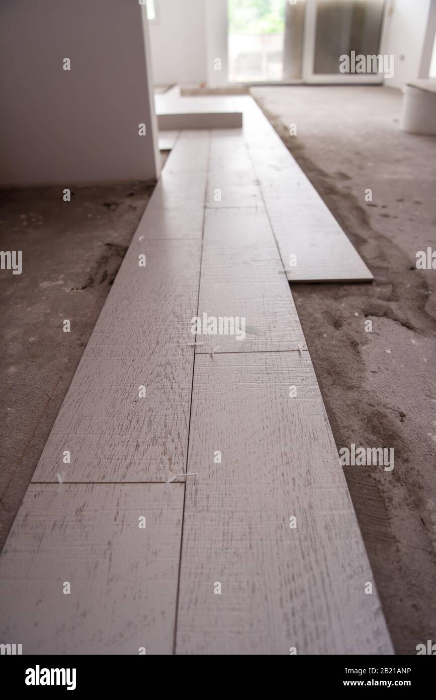 Ceramic wood effect tiles and tools for tiler on the floor unfinished ...