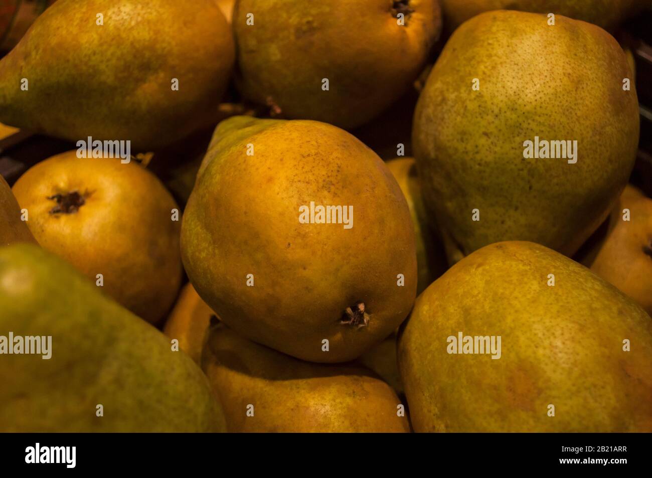 Yellow ripe pears lie on the window of a market, store, supermarket ...