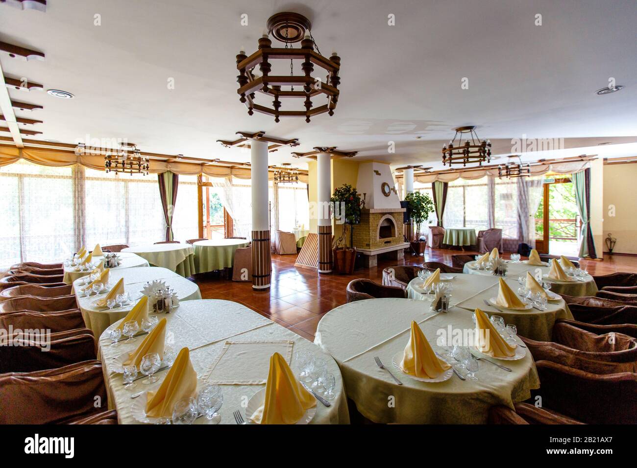 Large restaurant Hall with columns and fireplace. Canned tables. Greek ...