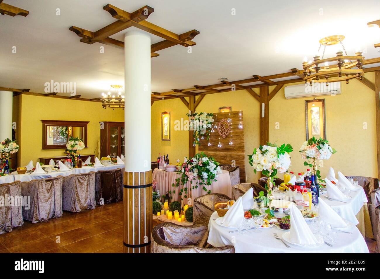 Large restaurant Hall with columns and fireplace. Canned tables. Greek ...