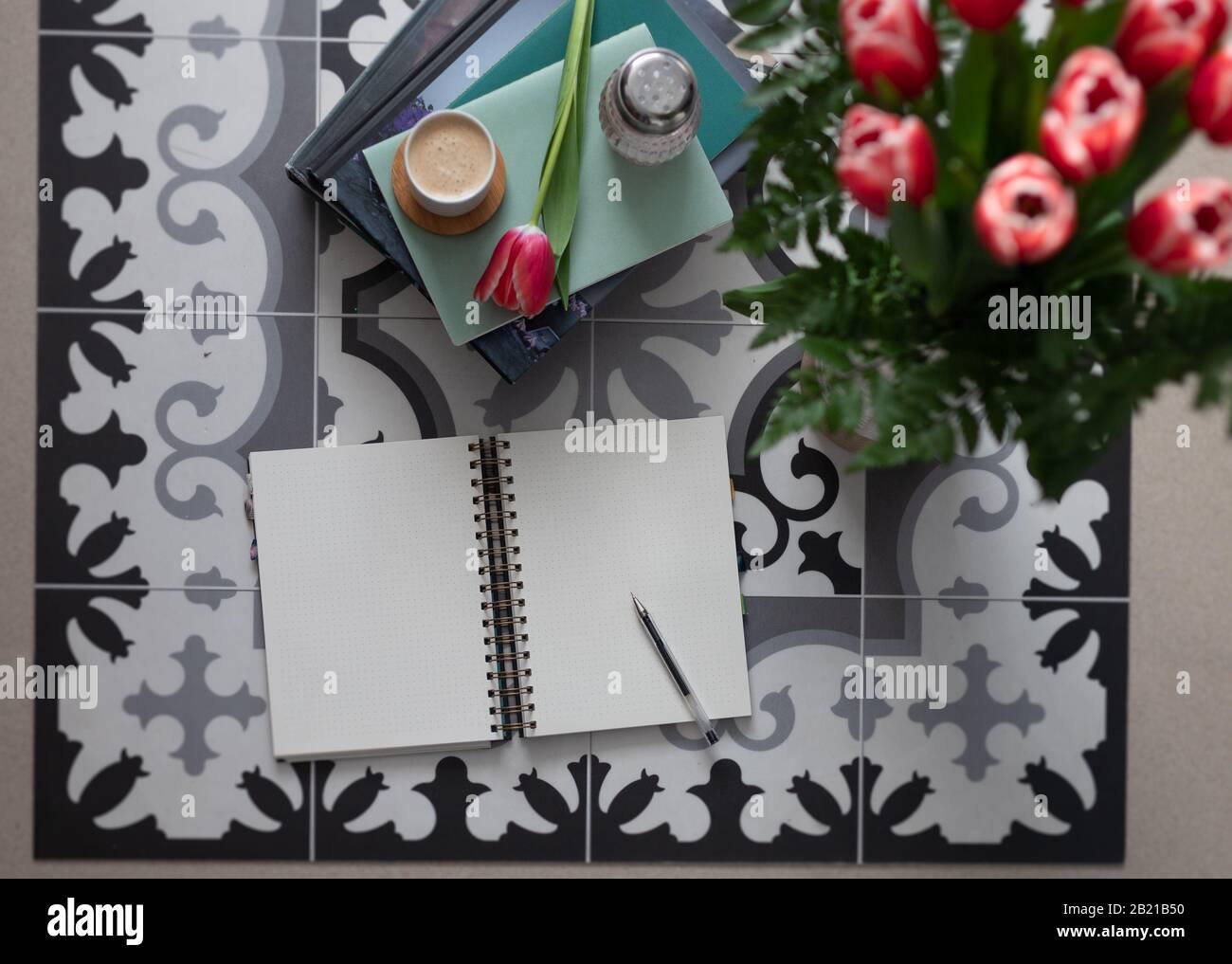 Overhead view of a pleasant scene with a still empty notebook with a ...