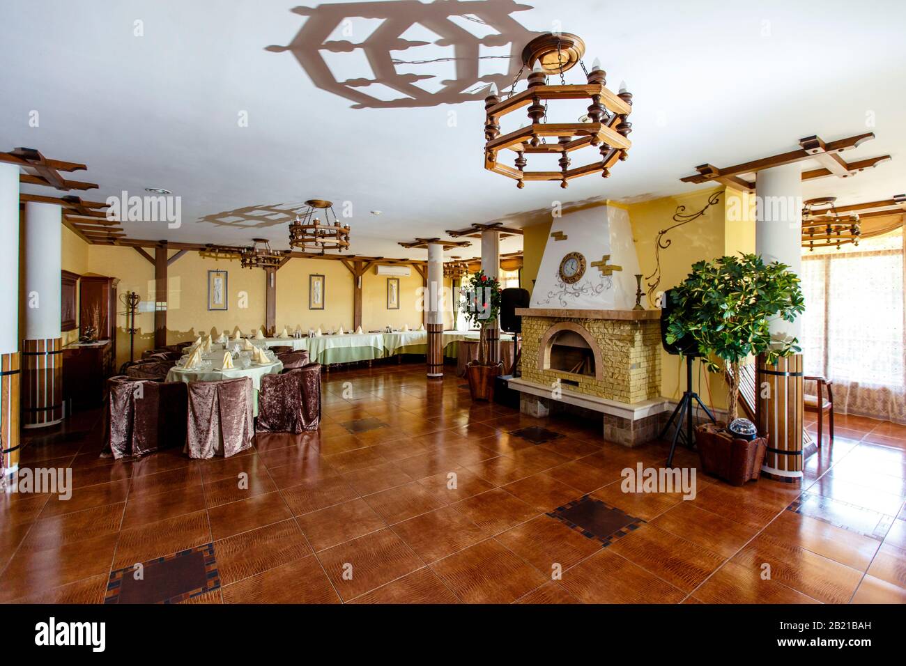 Large restaurant Hall with columns and fireplace. Canned tables. Greek ...