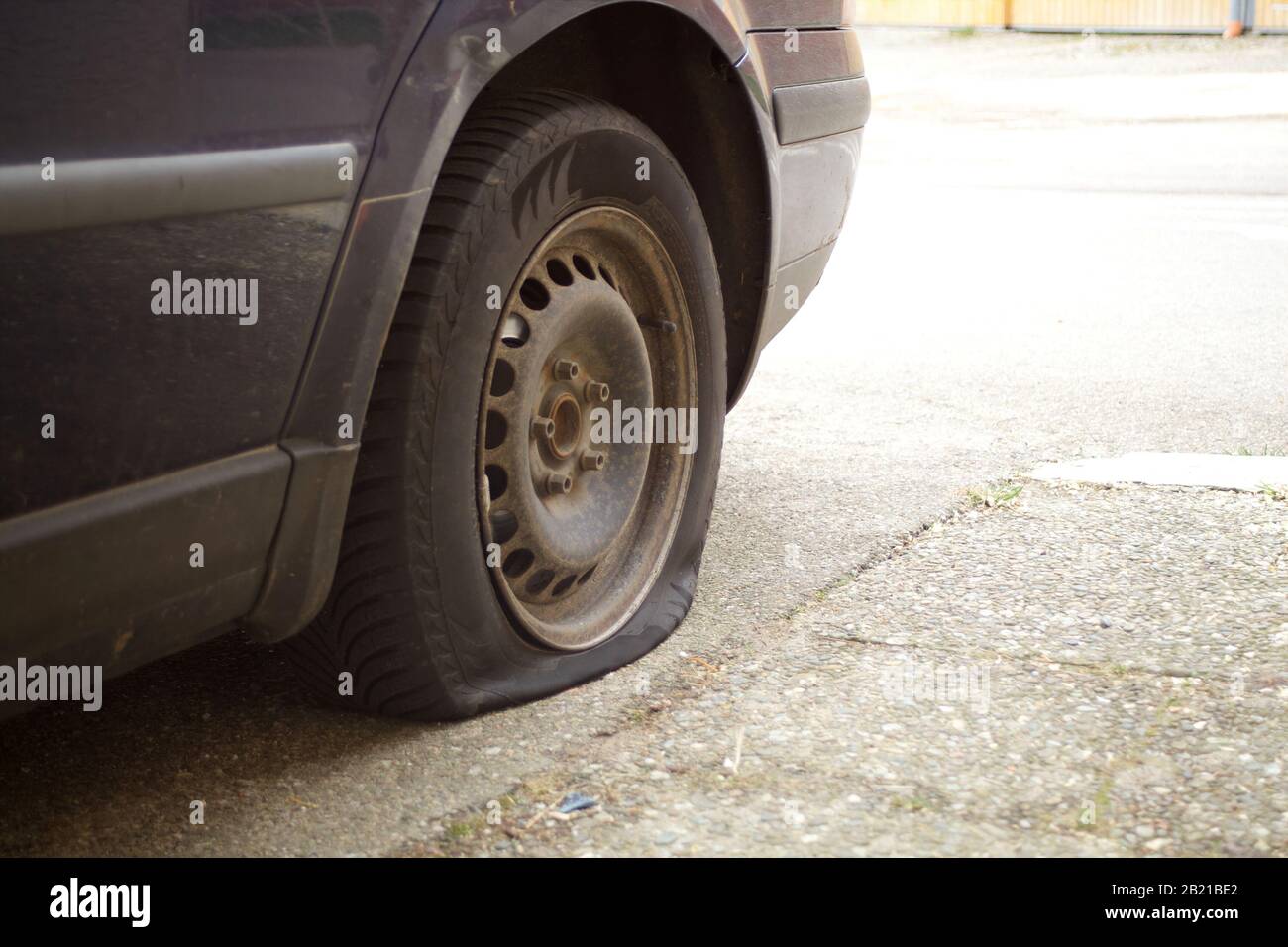 flat tire, damaged wheel on car lost aerial Stock Photo - Alamy