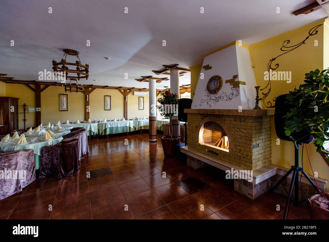 Large restaurant Hall with columns and fireplace. Canned tables. Greek ...