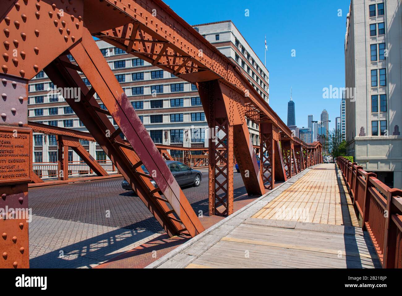 On the West Chicago Avenue bridge sidewalk, facing the city skyscrapers ...