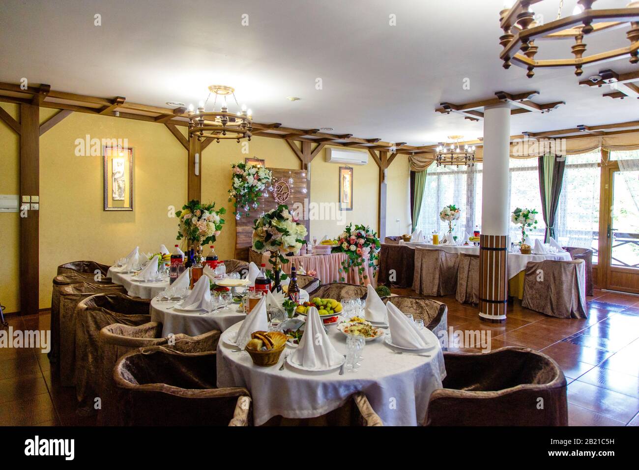 Large restaurant Hall with columns and fireplace. Canned tables. Greek ...