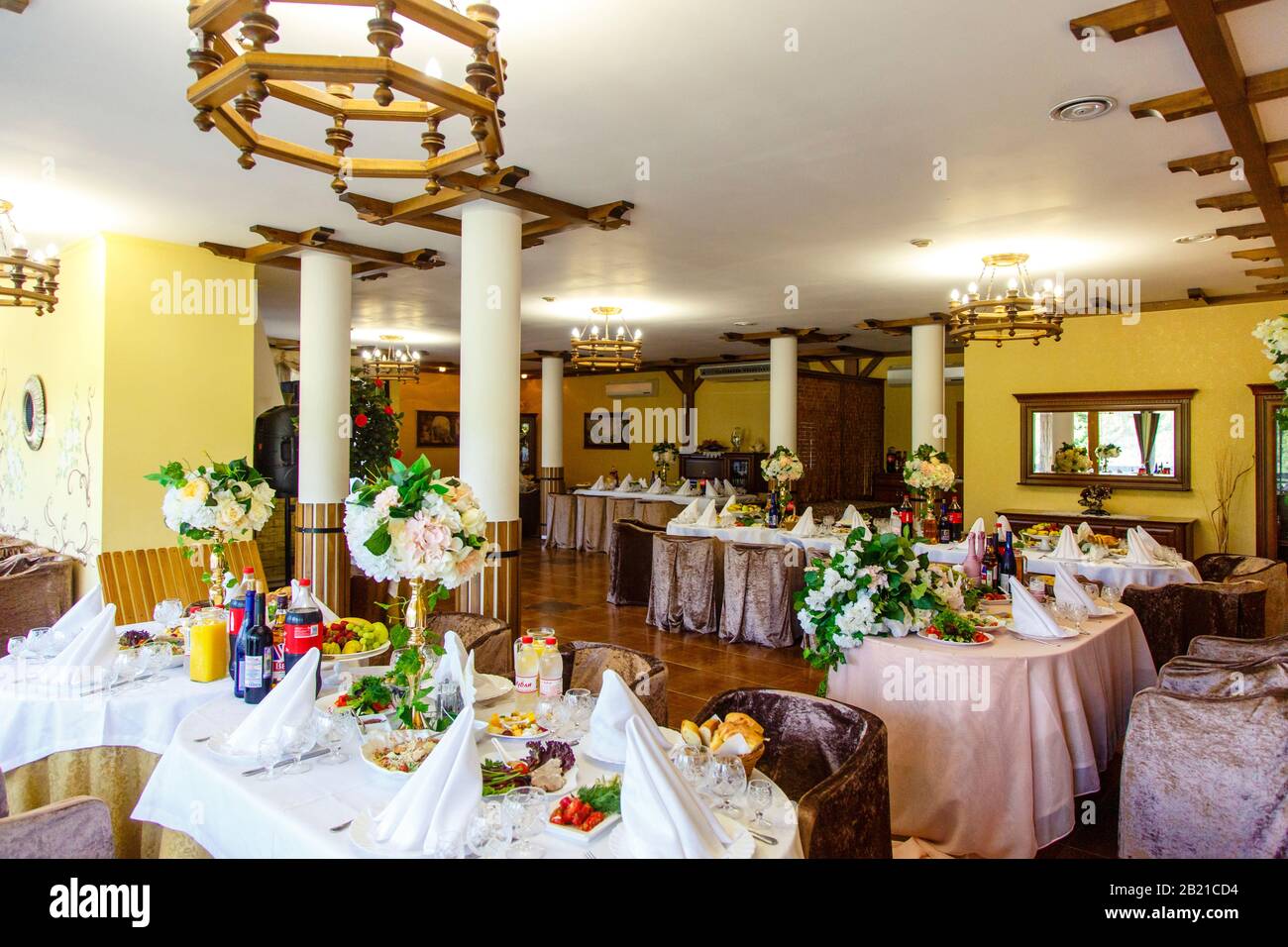 Large restaurant Hall with columns and fireplace. Canned tables. Greek ...