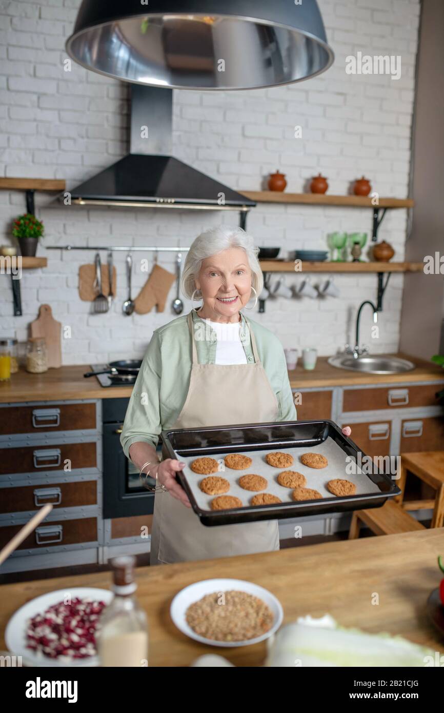 Elderly woman cooking pastry in her kitchen Stock Photo - Alamy