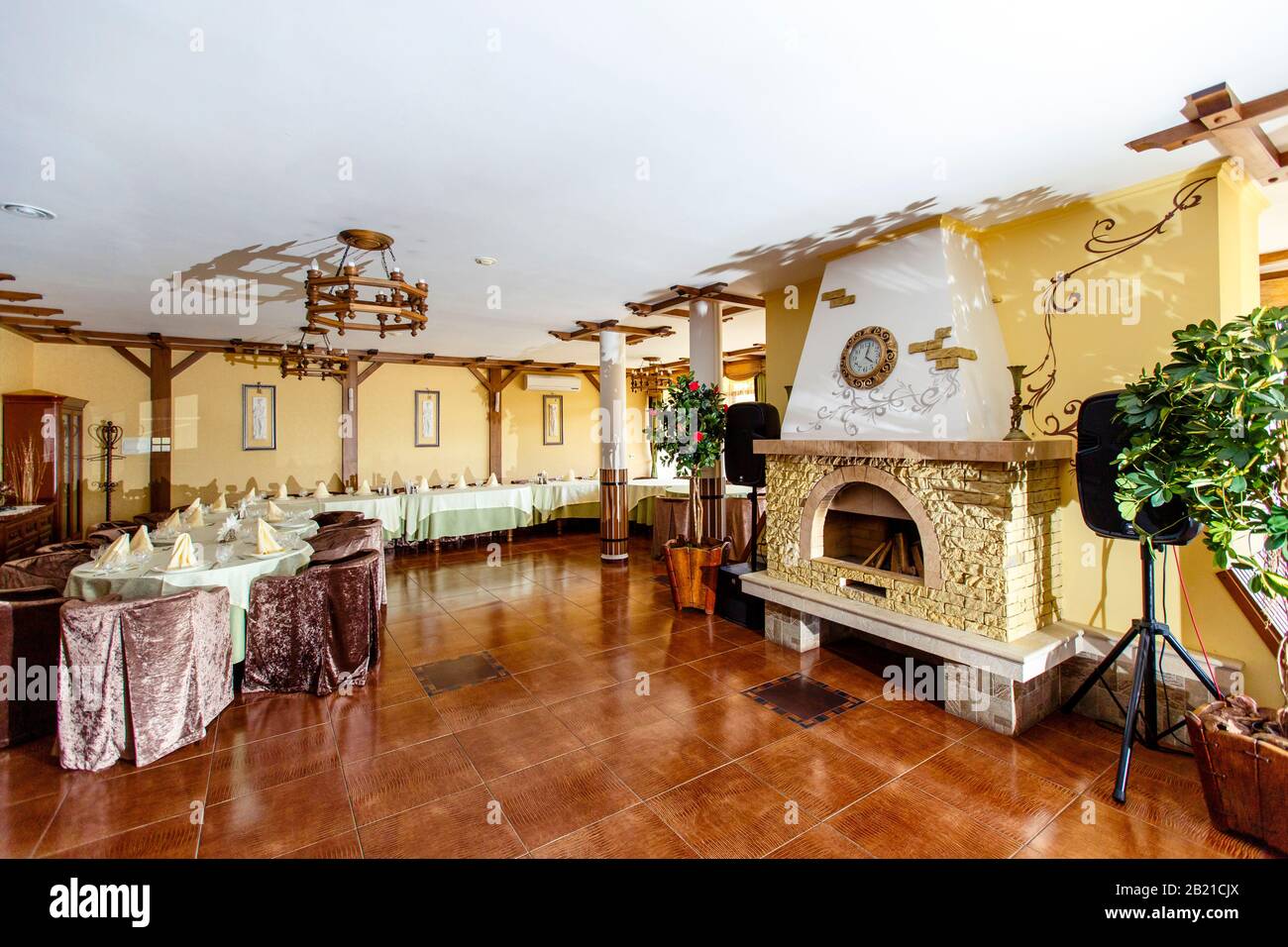 Large restaurant Hall with columns and fireplace. Canned tables. Greek ...