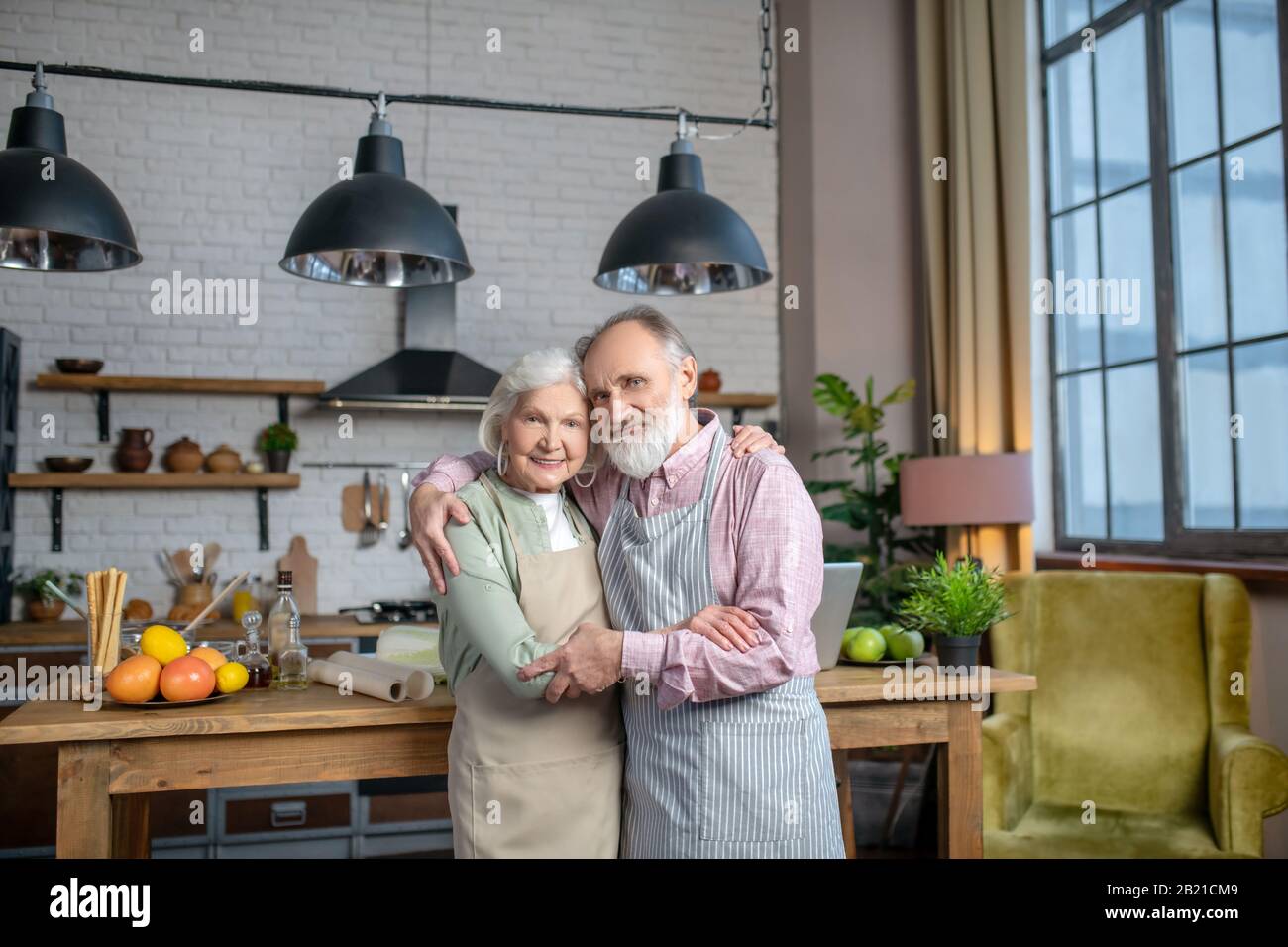 Two cheerful elderly people hugging each other Stock Photo - Alamy