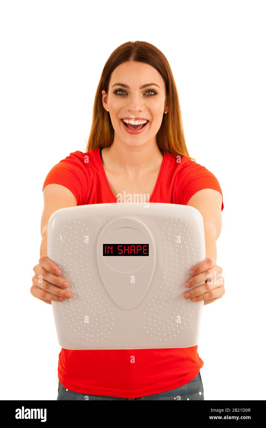Beautiful young woman holds scale as a sign of weightloss isolated over ...