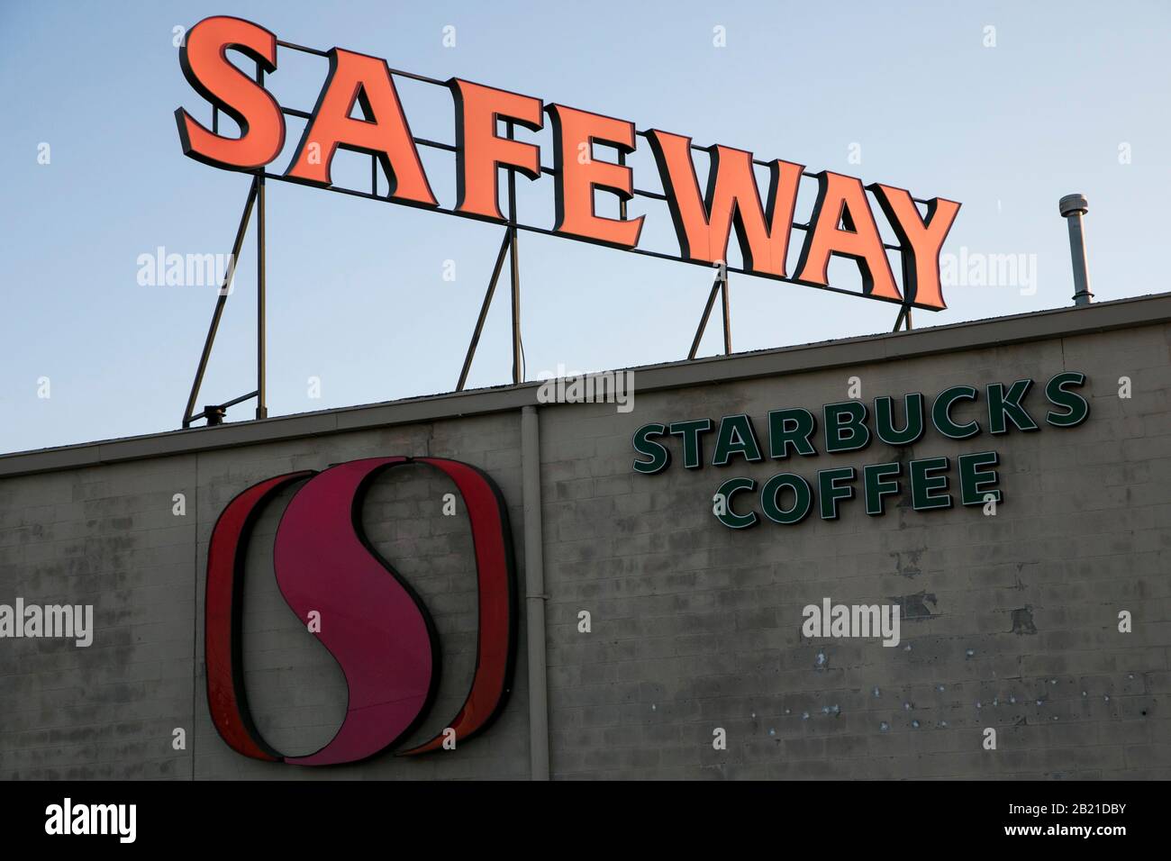 A logo sign outside of a Safeway retail grocery store location in ...