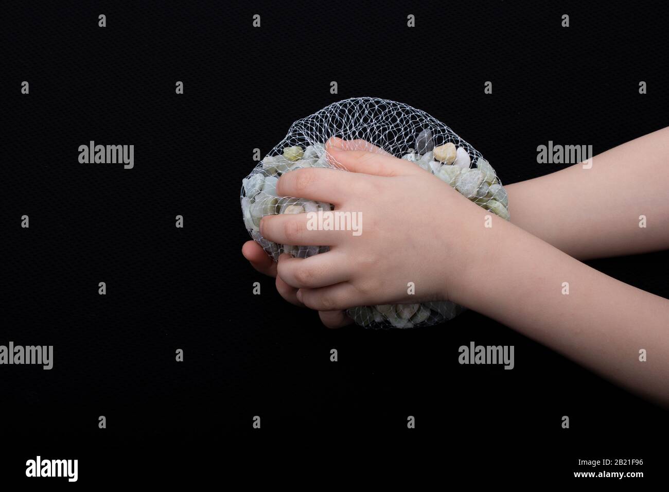 Handful of clean pebbles, gravels in hands Stock Photo - Alamy