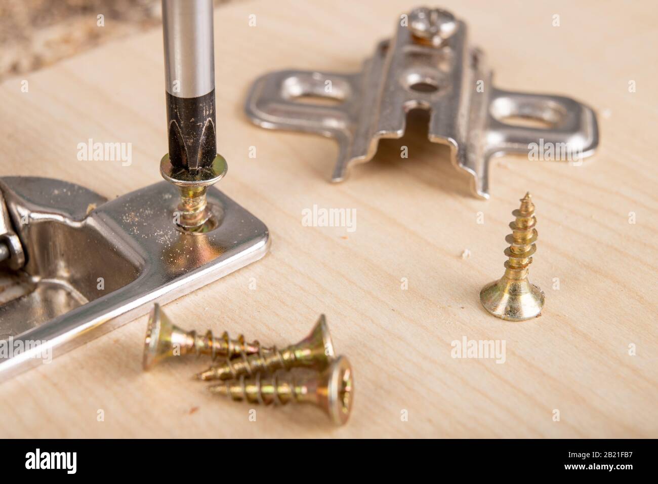 Installation of furniture hinges in chipboard. Small carpentry work in ...