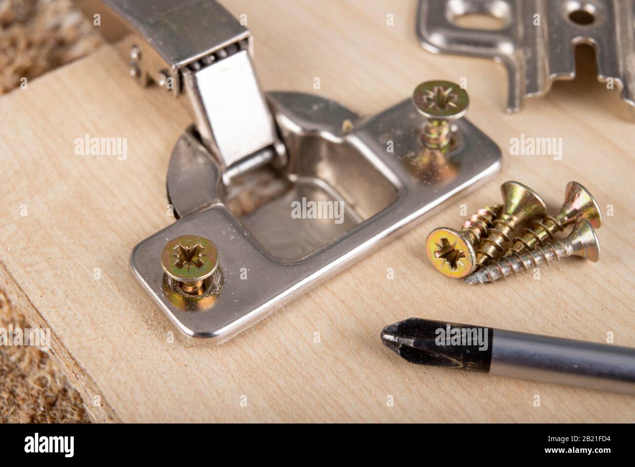 Installation of furniture hinges in chipboard. Small carpentry work in ...