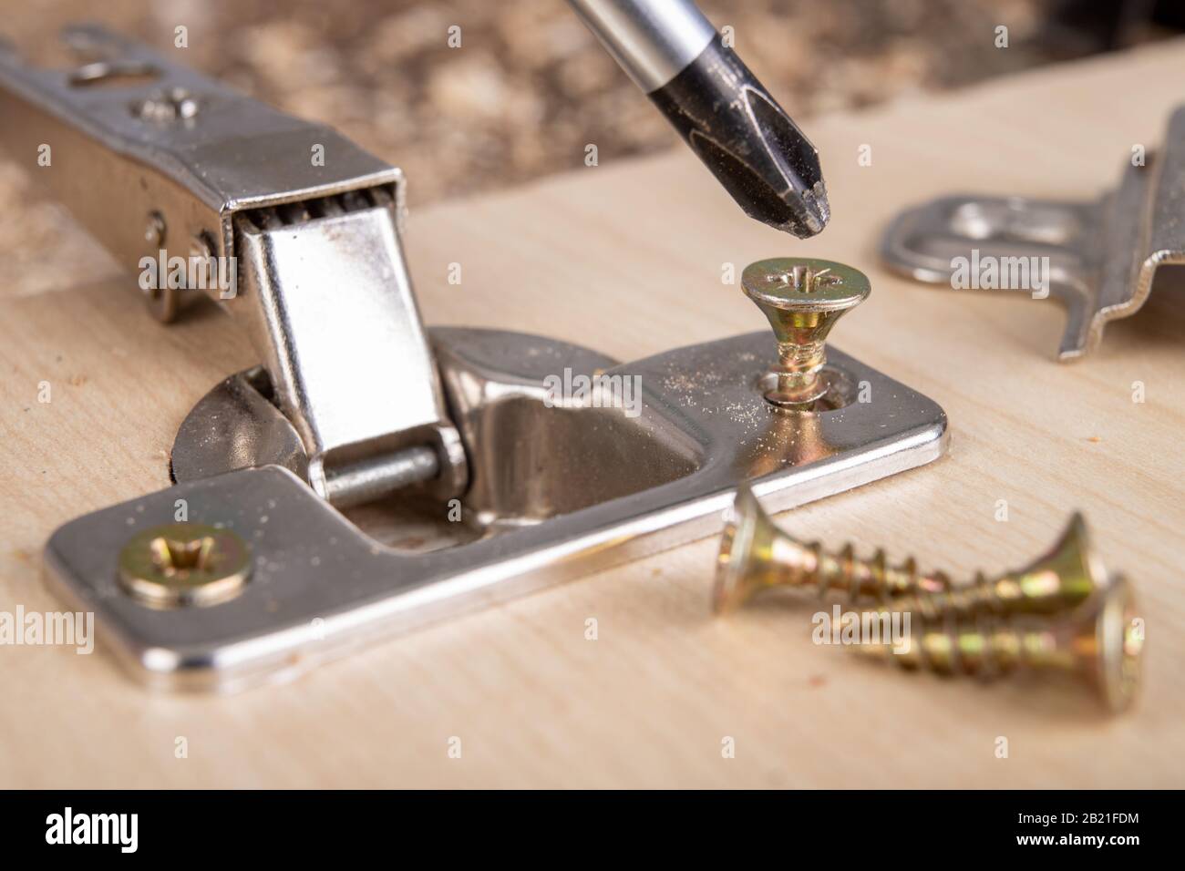 Installation of furniture hinges in chipboard. Small carpentry work in ...