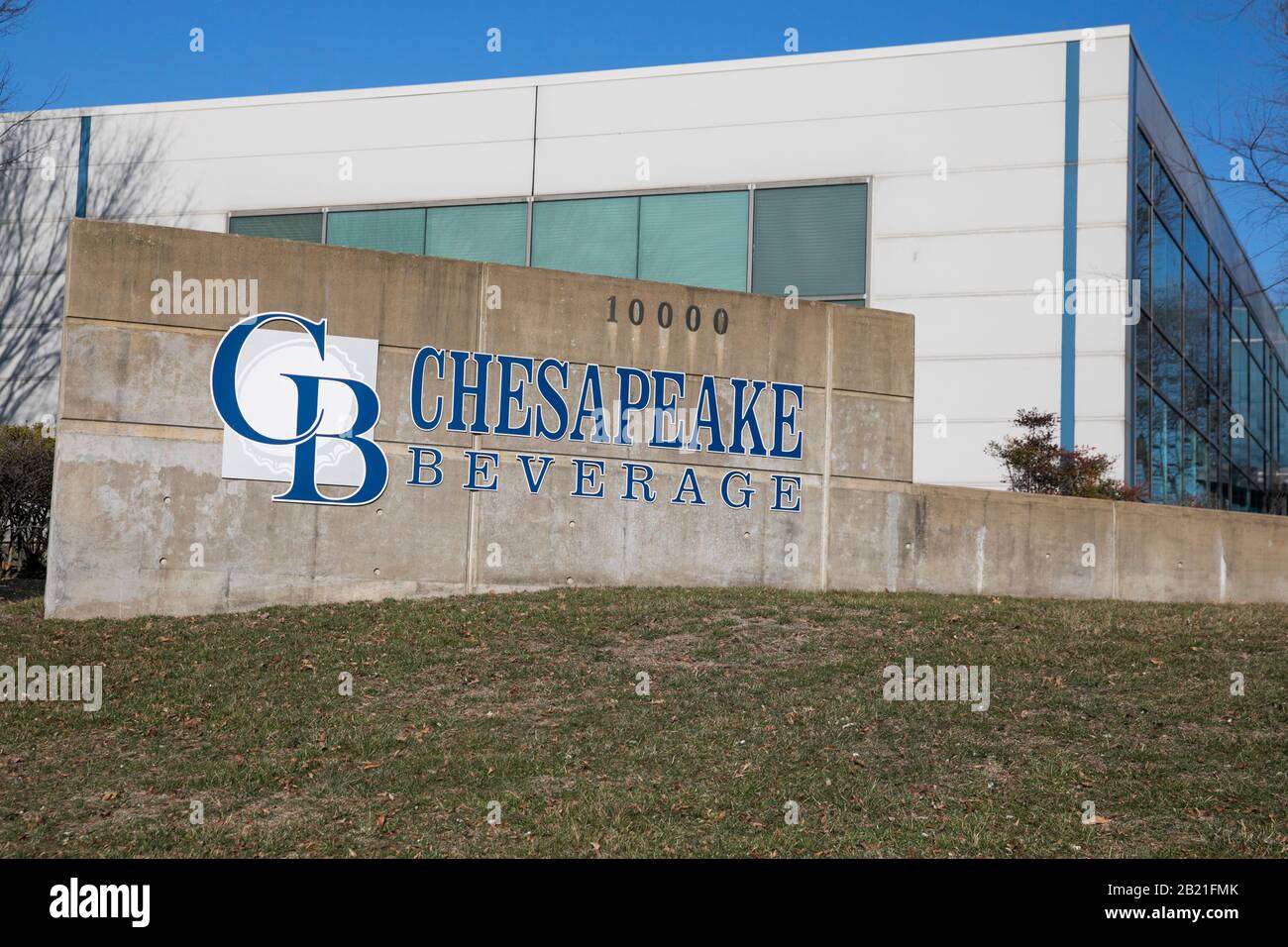 A logo sign outside of a facility occupied by Chesapeake Beverage in ...