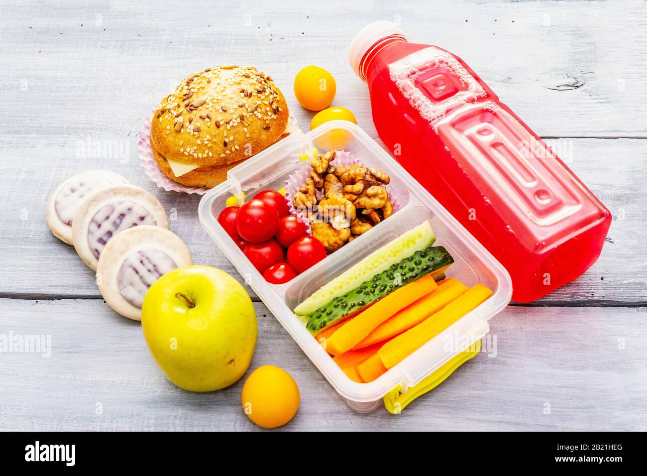 School lunch box with sandwich, fresh fruits, vegetables, juice and ...