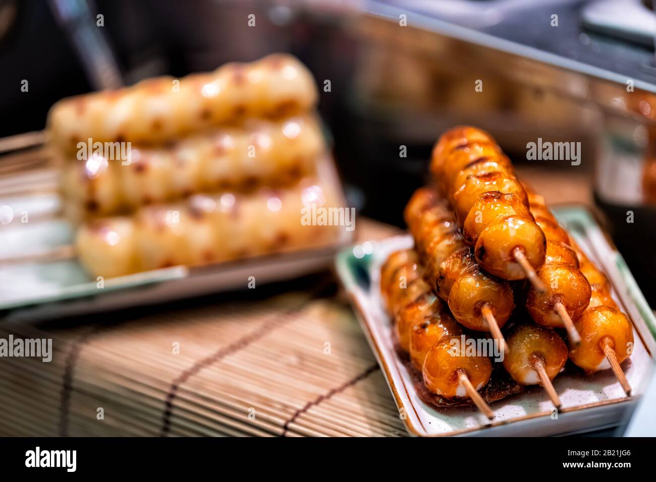 Display of hot mochi dango snack with rice cake and miso soy sauce ...