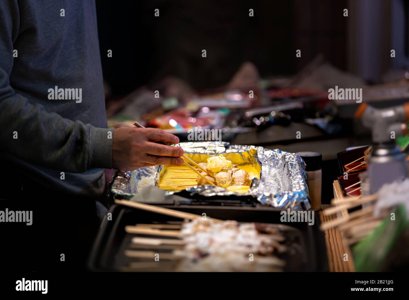 Kyoto, Japan people man chef serving cooking at Nishiki market shops ...