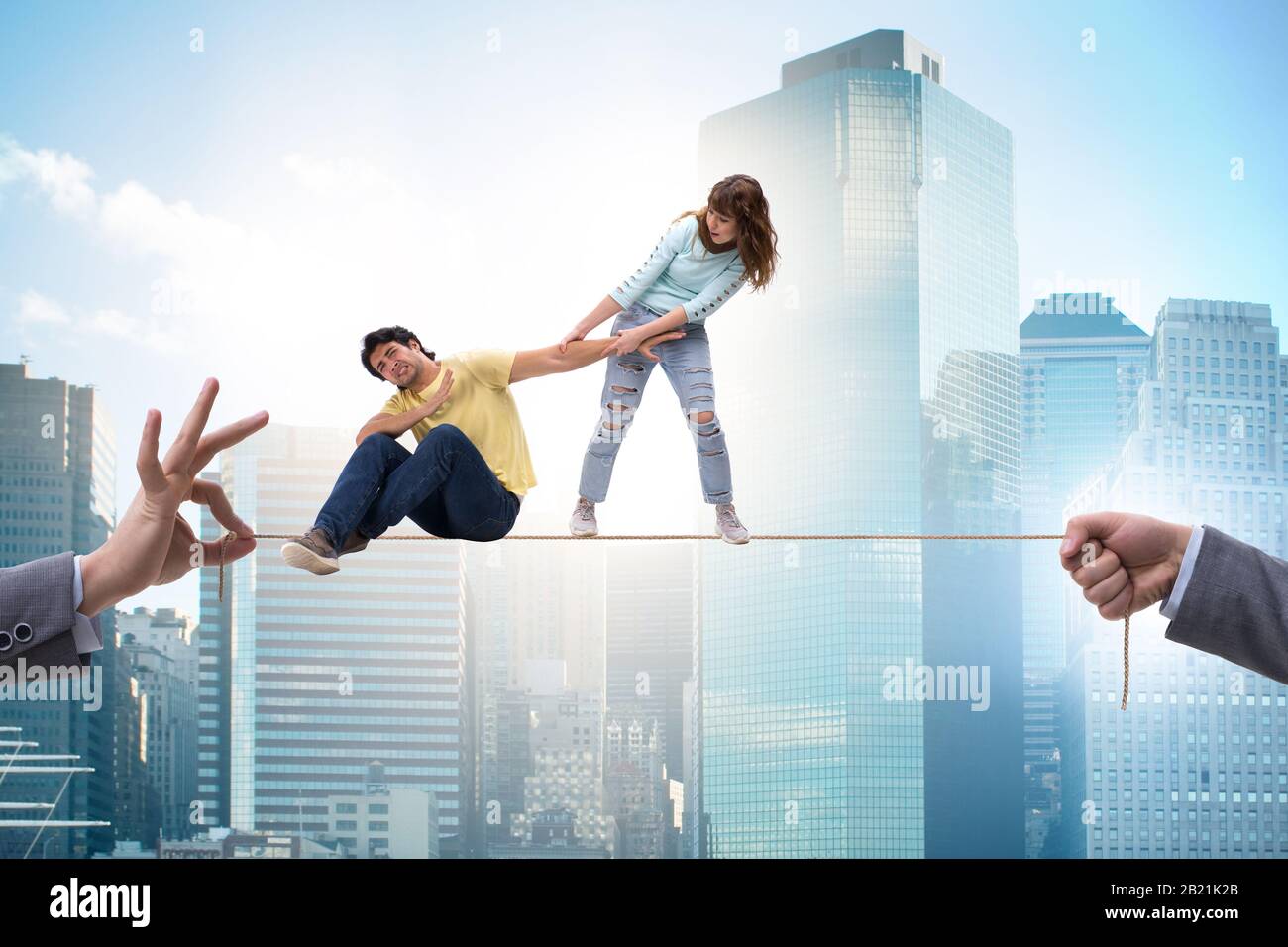 The young family on tight rope Stock Photo - Alamy