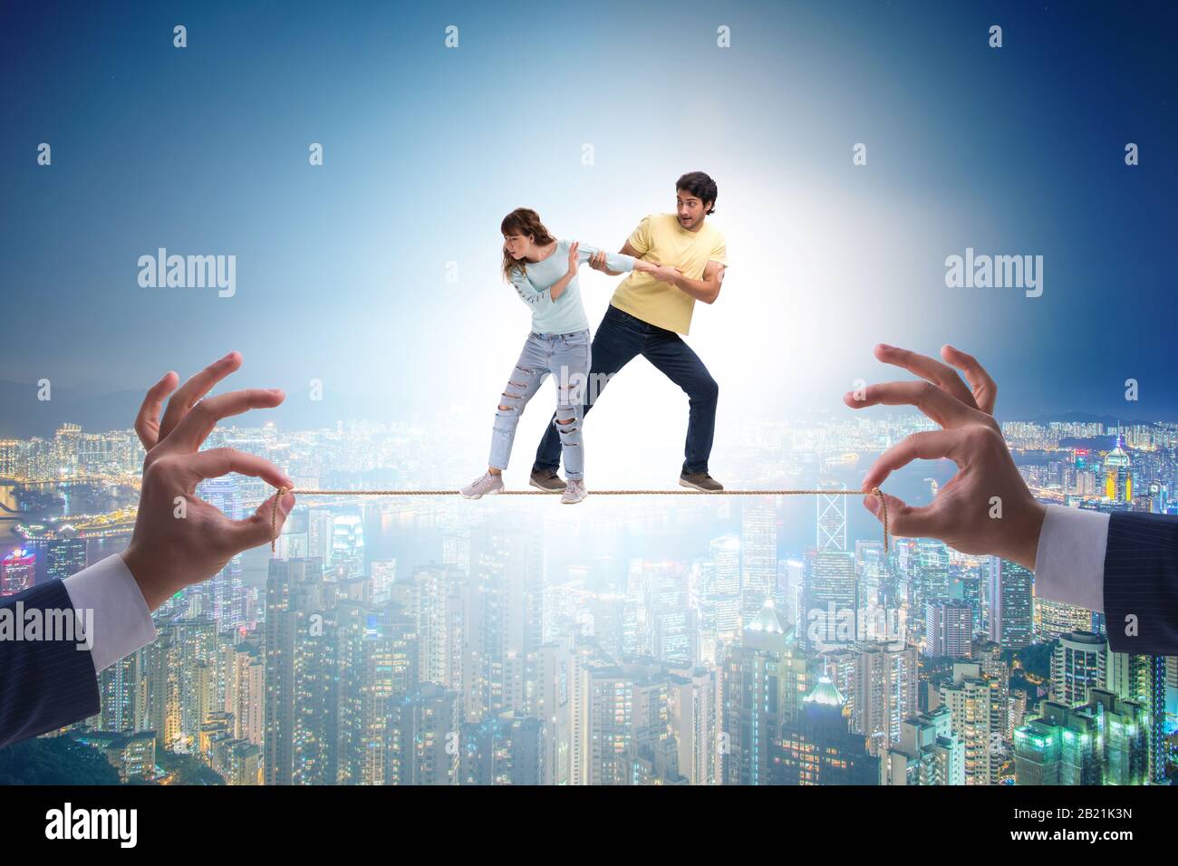 The young family on tight rope Stock Photo - Alamy