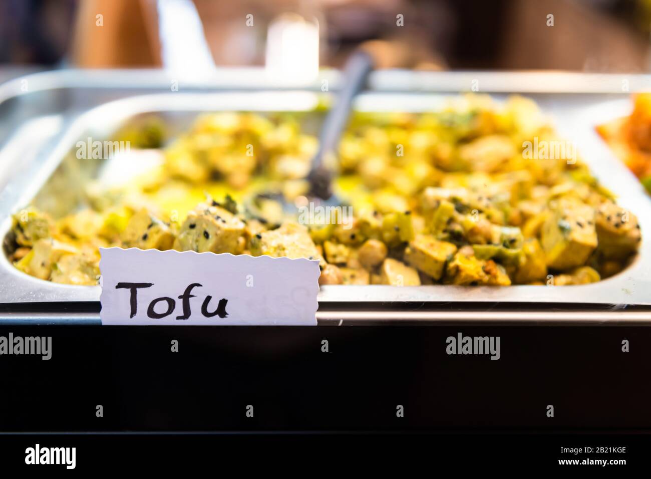 Cooked tofu cubes with vegetables in market shop grocery display in ...