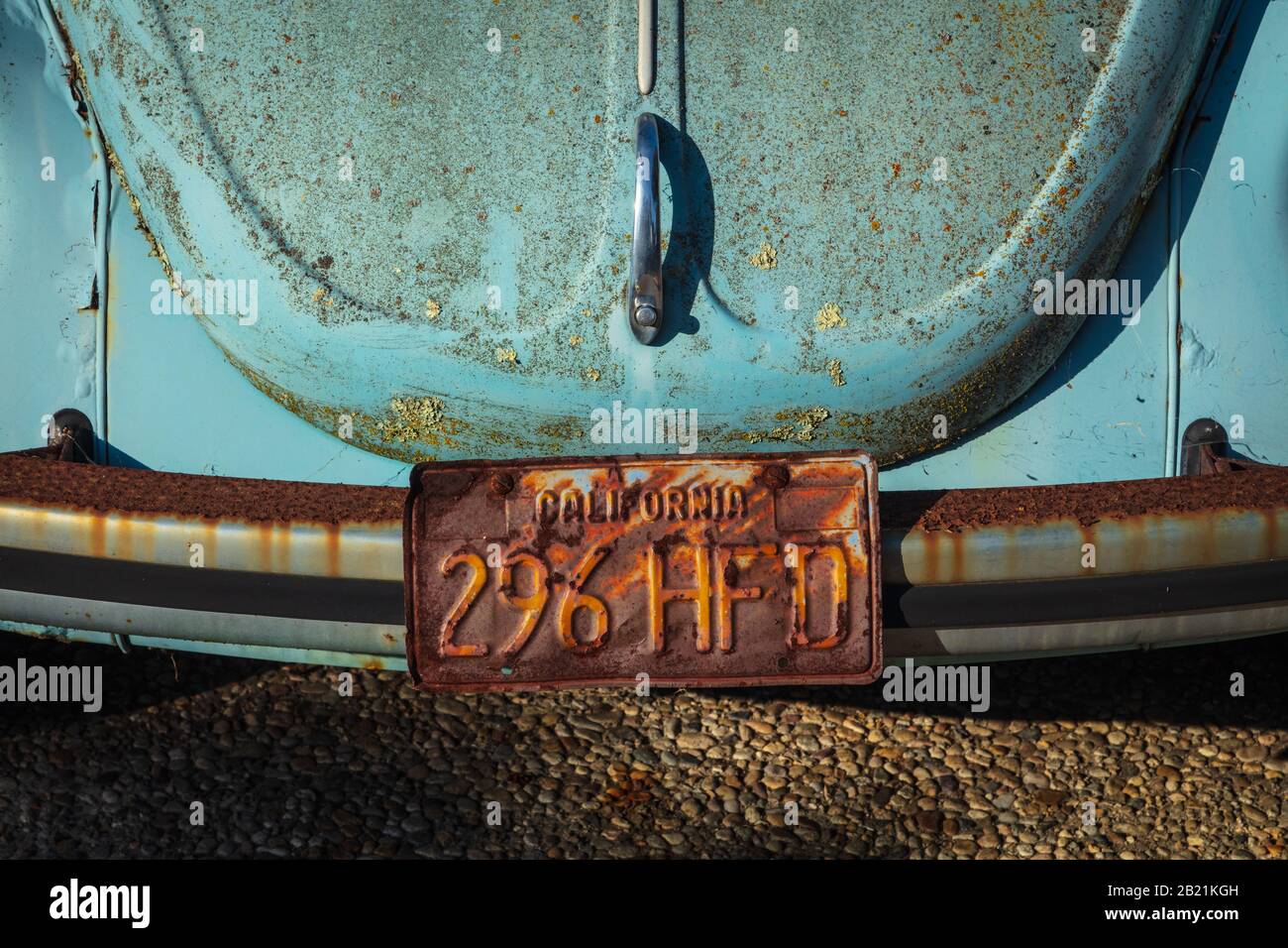 An old rusty and dirty car closeup of its front bumper and ...