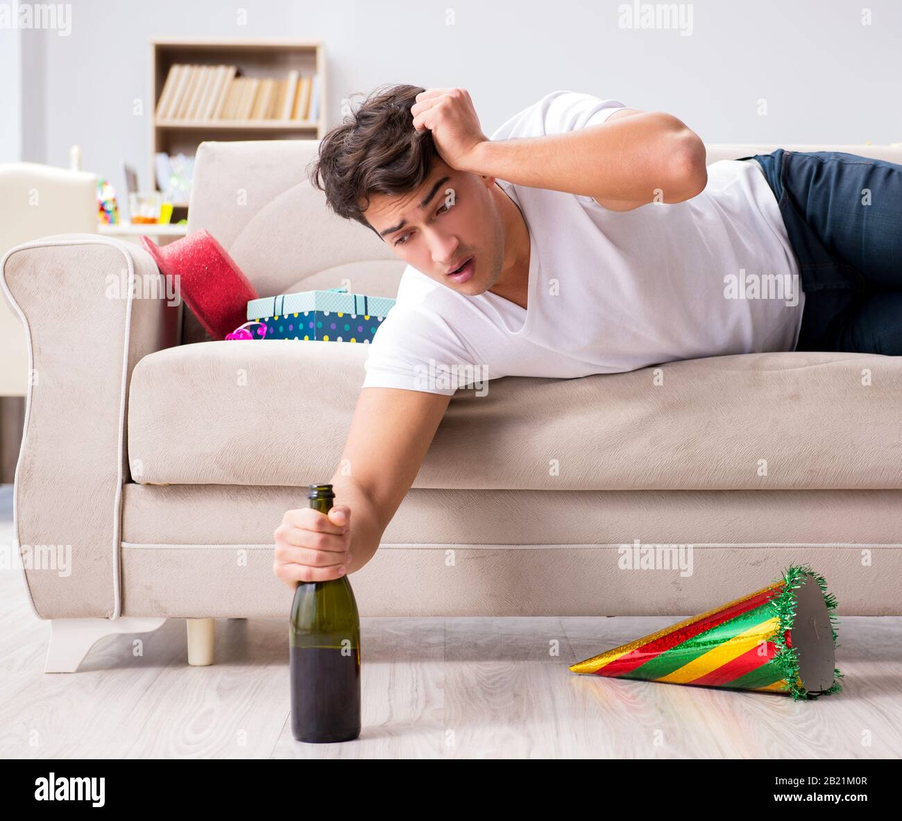 The man at home after heavy partying Stock Photo - Alamy