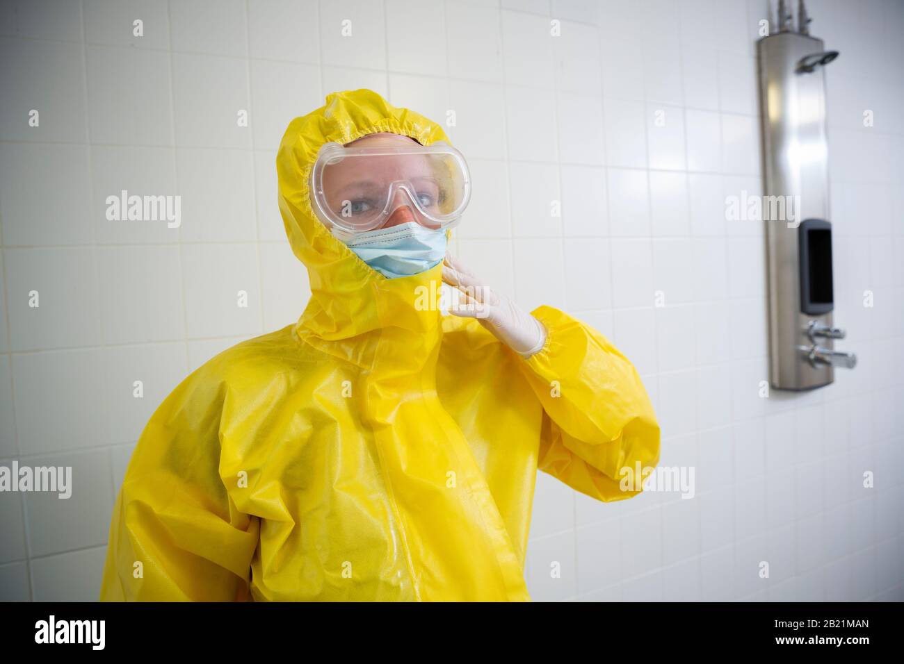 Woman in a yellow full protected suit Stock Photo - Alamy