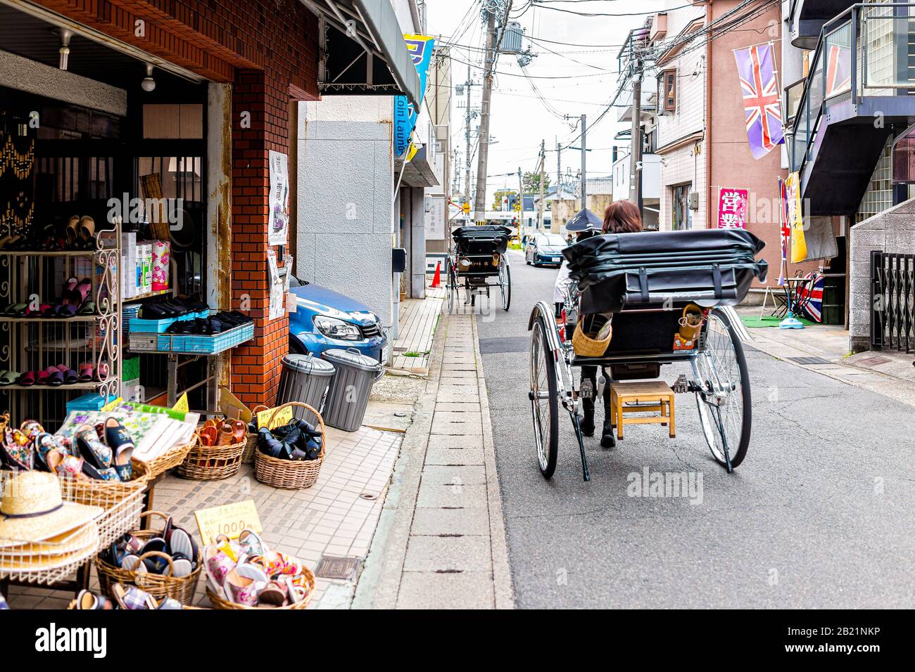 Japanese man pulling rickshaw with tourists hi-res stock photography ...