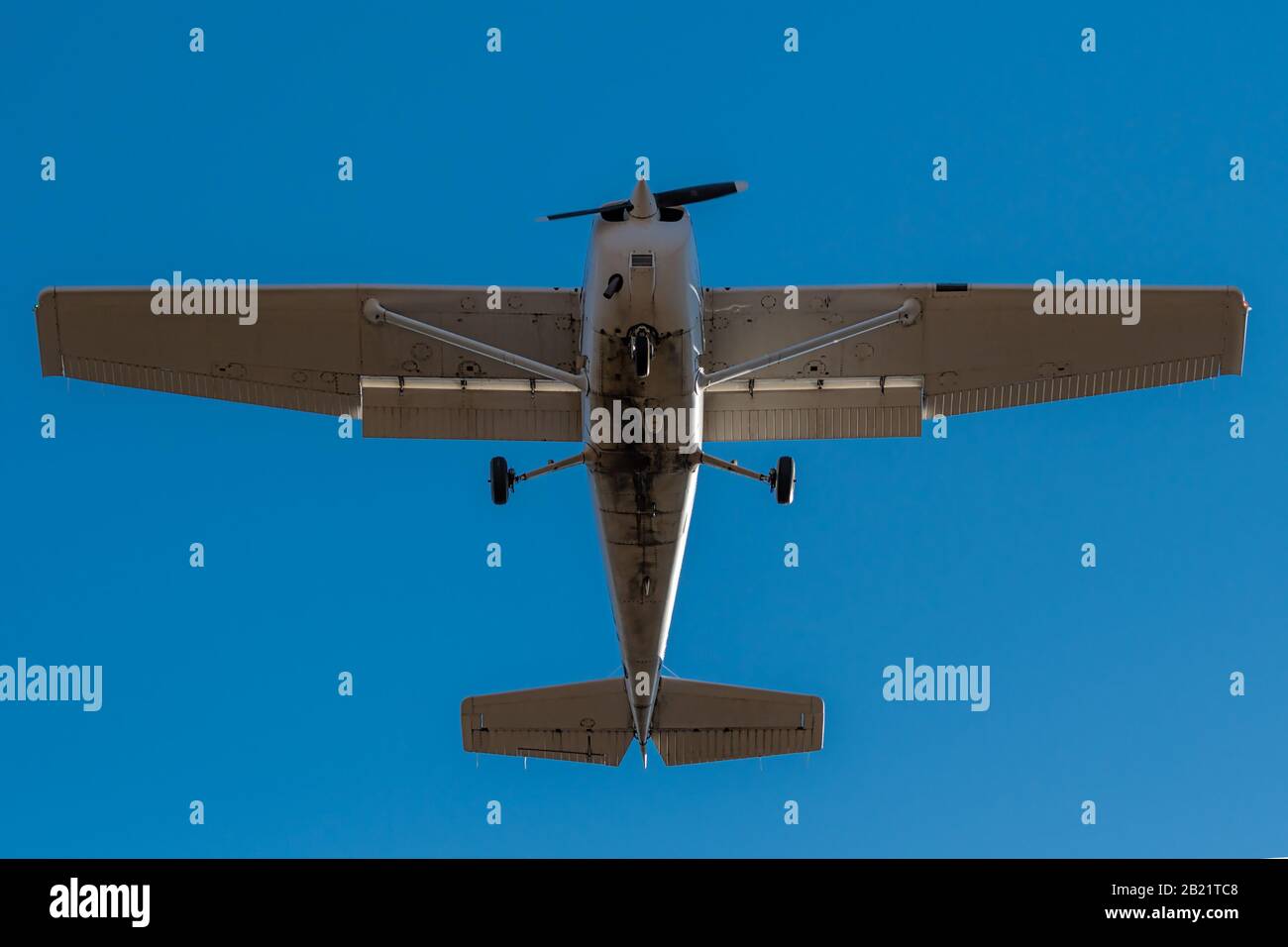 A small single engine airplane directly overhead. Blue sky above. Fast ...