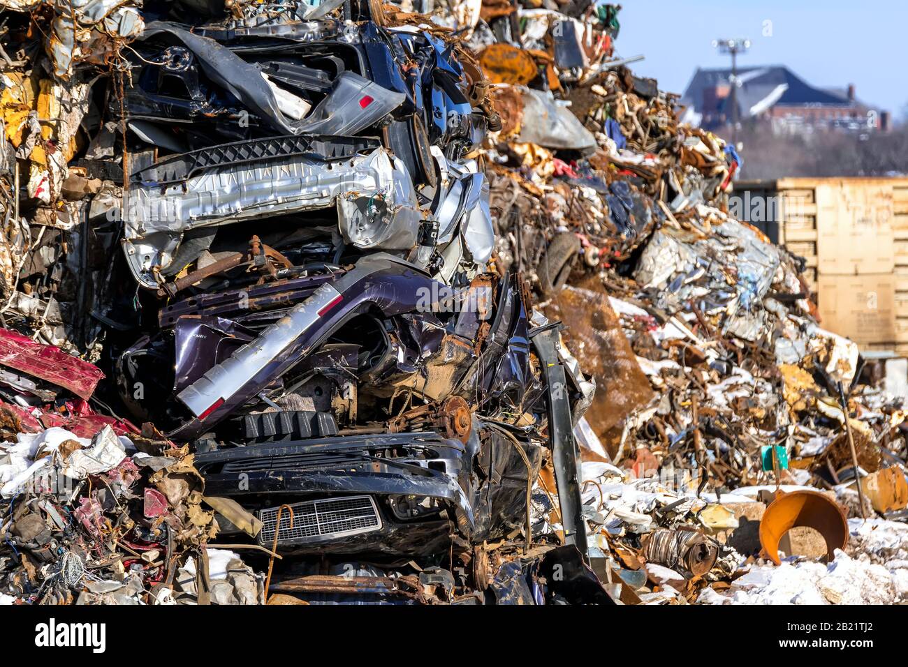 A large pile of scrap metal at a recycling yard. Unidentifiable cars ...
