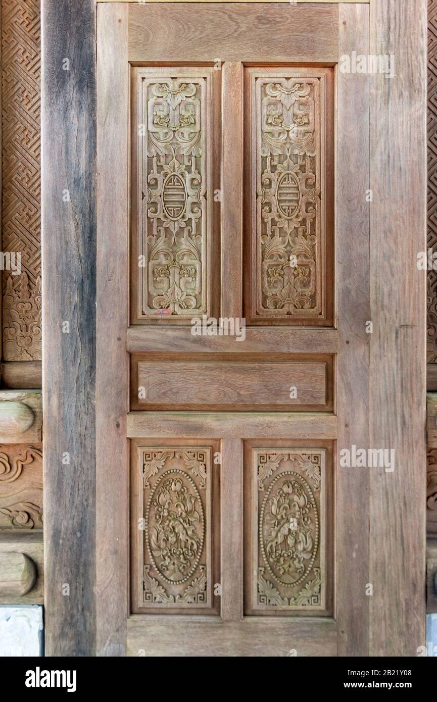 Traditional Buddhist pattern and motifs, swastika on a wooden door and ...